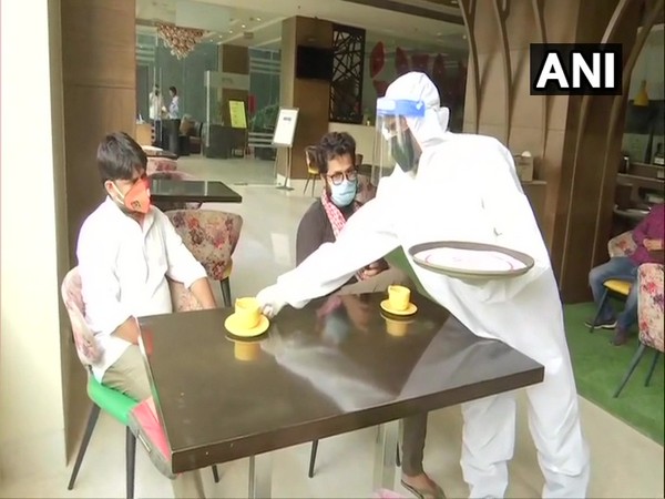 Hotel staff serve its customers wearing PPE kits in Patna