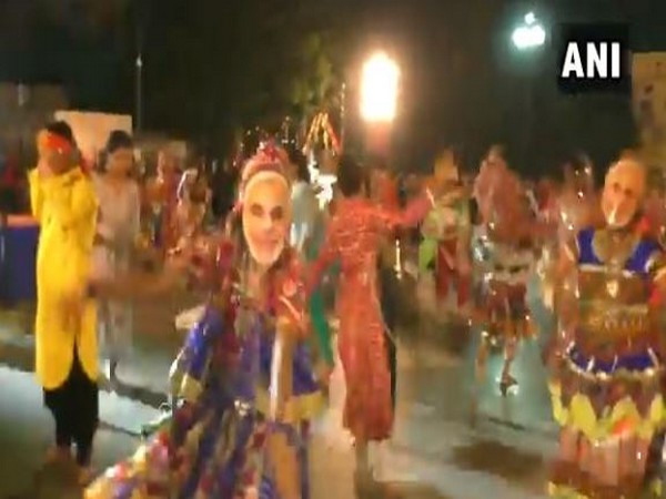 Gujarat: People wear Modi masks while performing 'Garba' in Surat